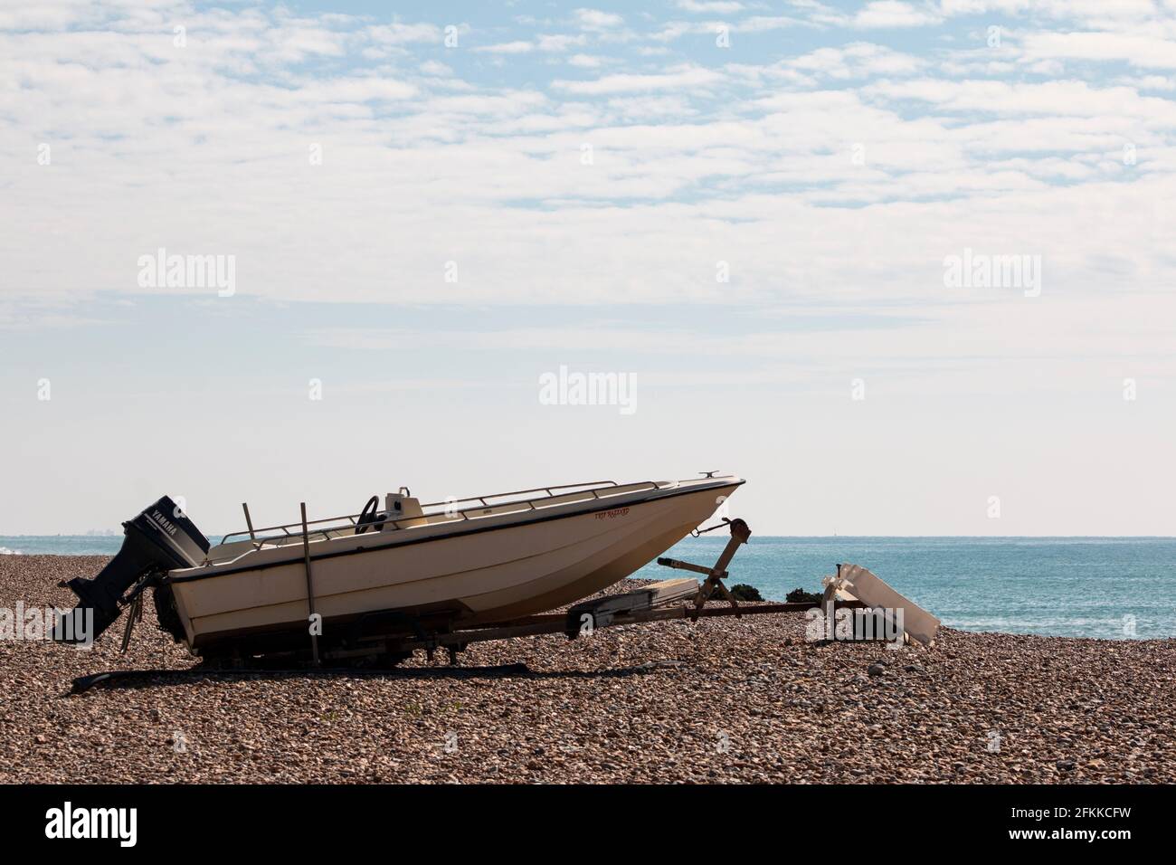 speed boat resting on a pebble beach in West Sussex,UK Stock Photo - Alamy