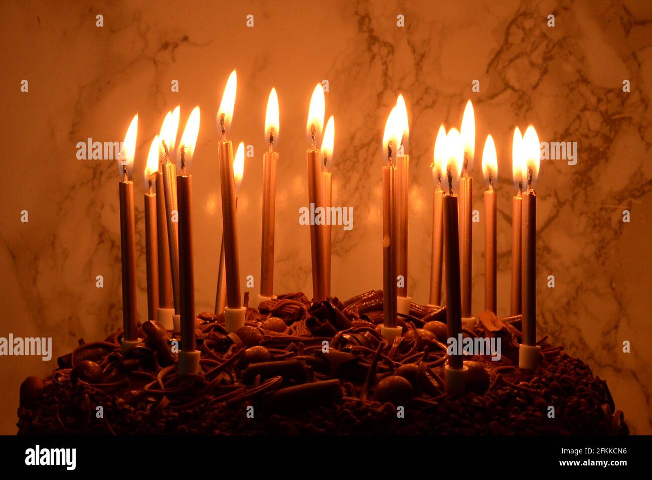 Lit Candles on chocolate birthday cake Stock Photo - Alamy