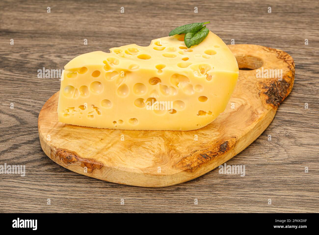 Maasdam cheese - dairy yellow triangle with holes Stock Photo - Alamy