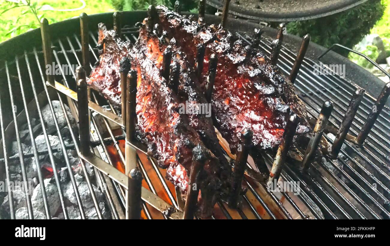 Yummy pork ribs are roasted on the grill outdoor Stock Photo - Alamy