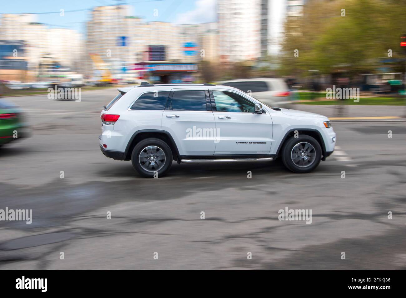 Ukraine, Kyiv - 26 April 2021: White Jeep Grand Cherokee car moving on ...