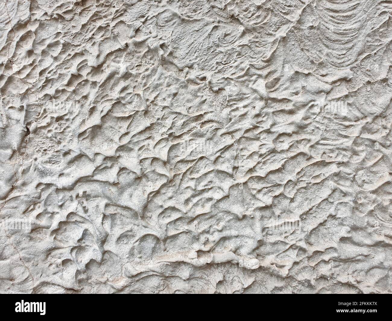 textured colored facing plaster of the street wall of the building ...