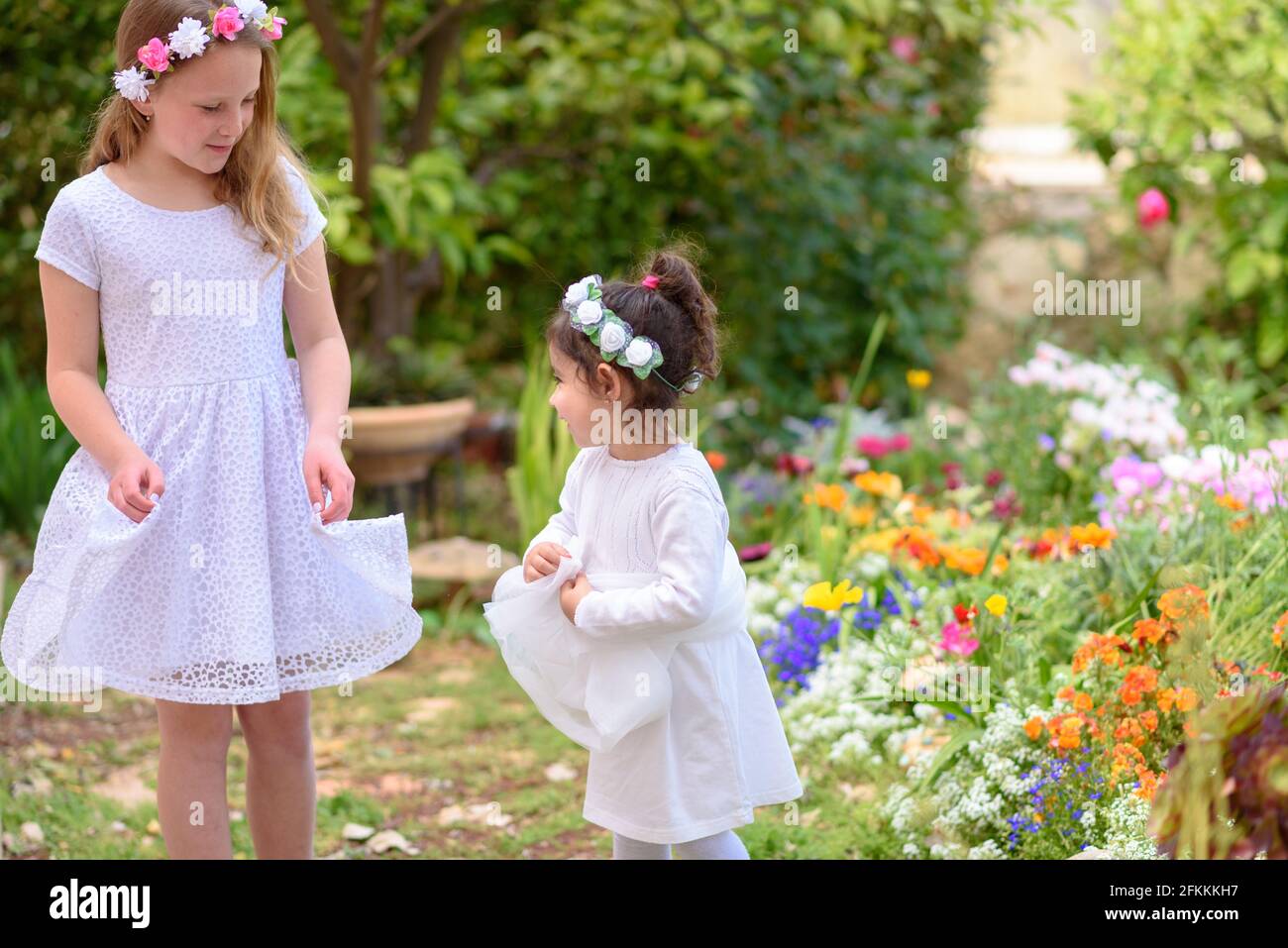 Two happy multiracial children with white dress playing outdoors. Kids ...