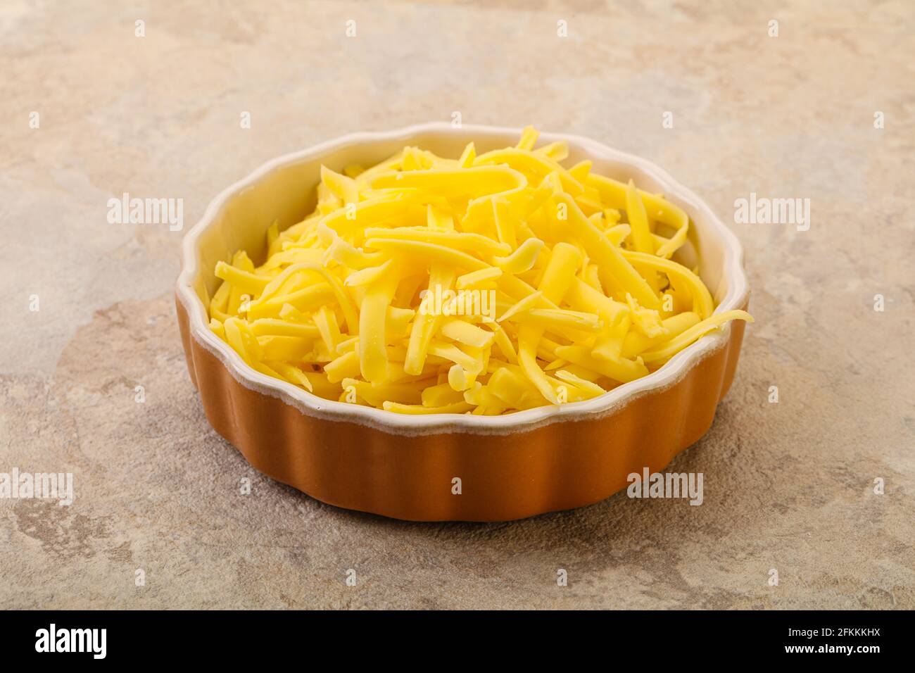 Shredded yellow cheese in the bowl for cooking Stock Photo - Alamy