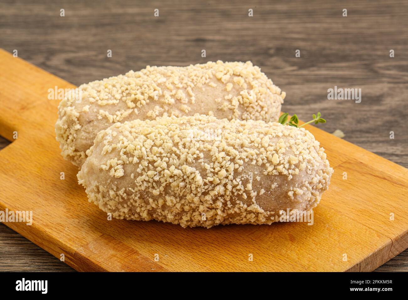 Raw breaded chicken cutlet for roast Stock Photo - Alamy