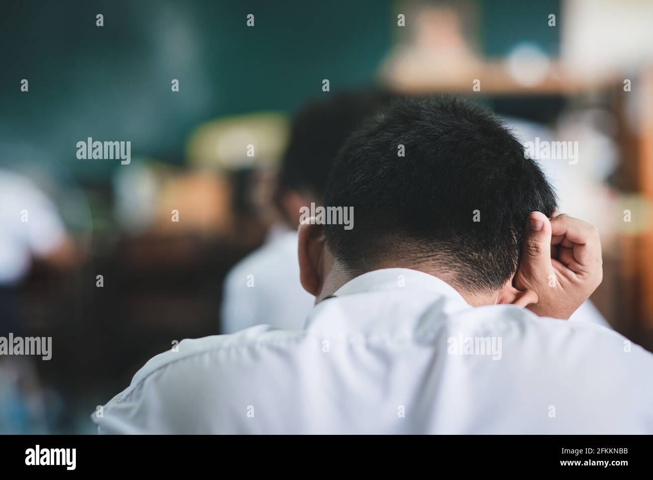 Students taking exam with stress in school classroom Stock Photo - Alamy