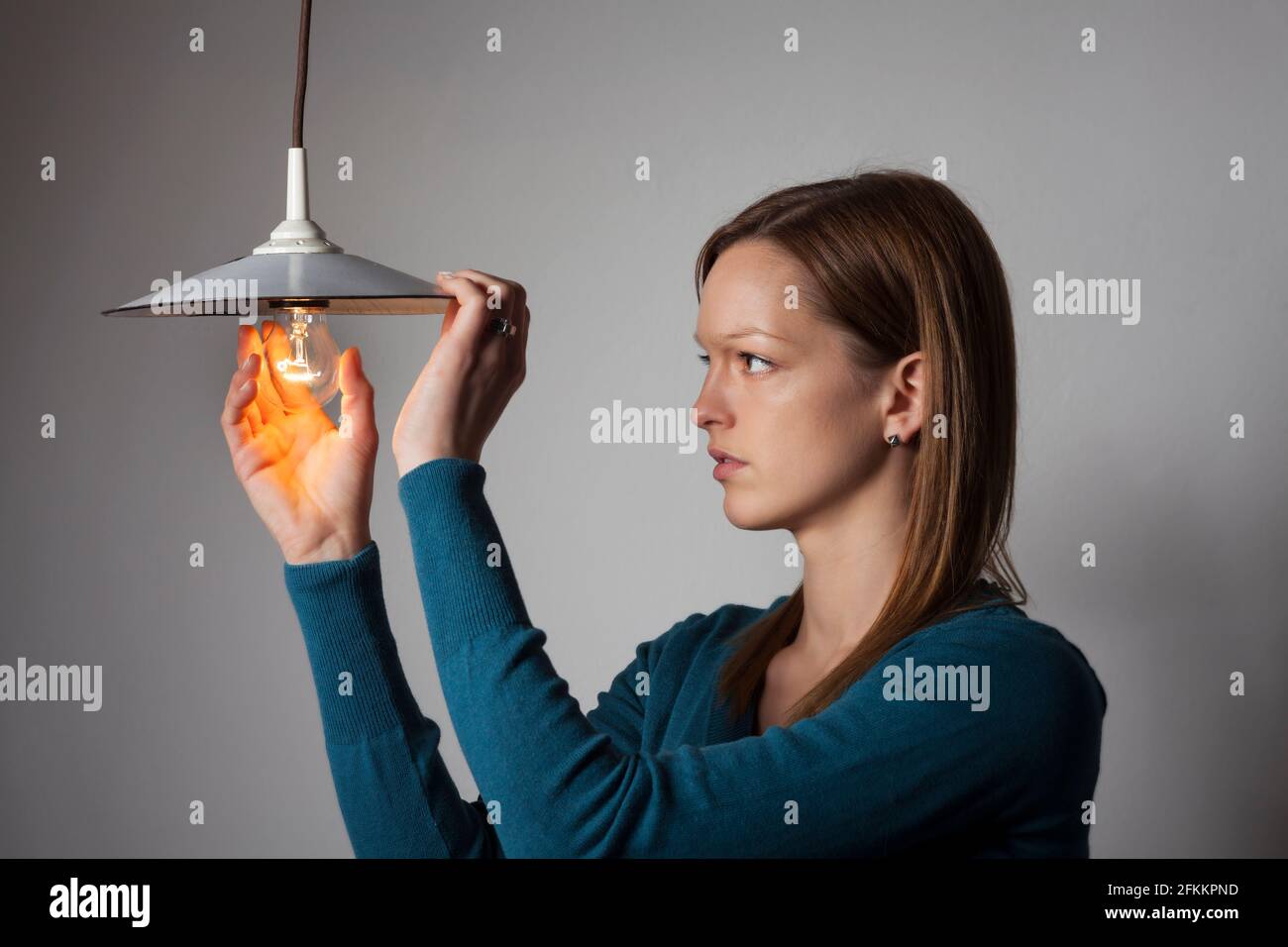 woman with a light bulb on white Stock Photo - Alamy
