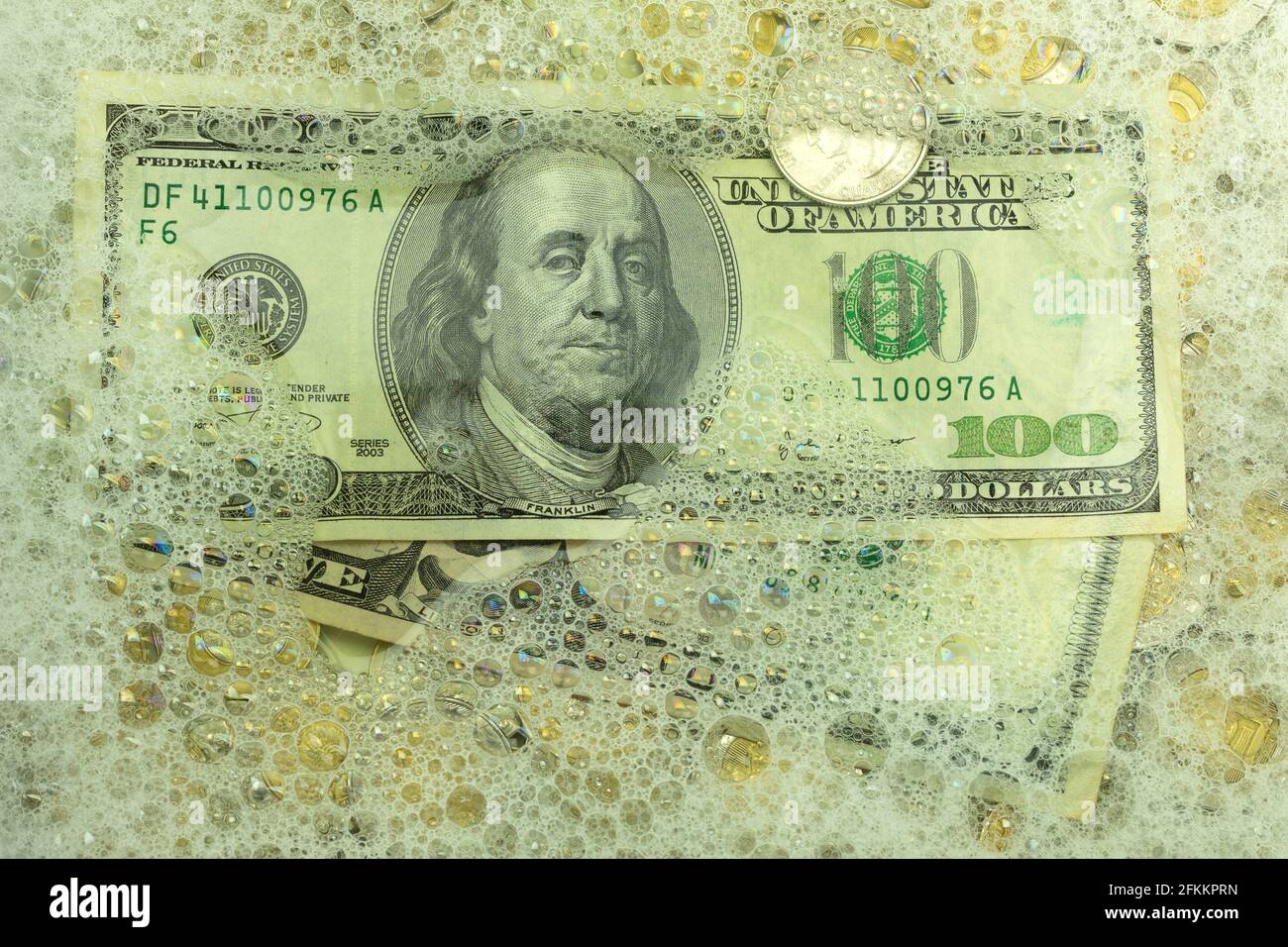 Money laundering concept, dollars in soapy water. Laundering of ...