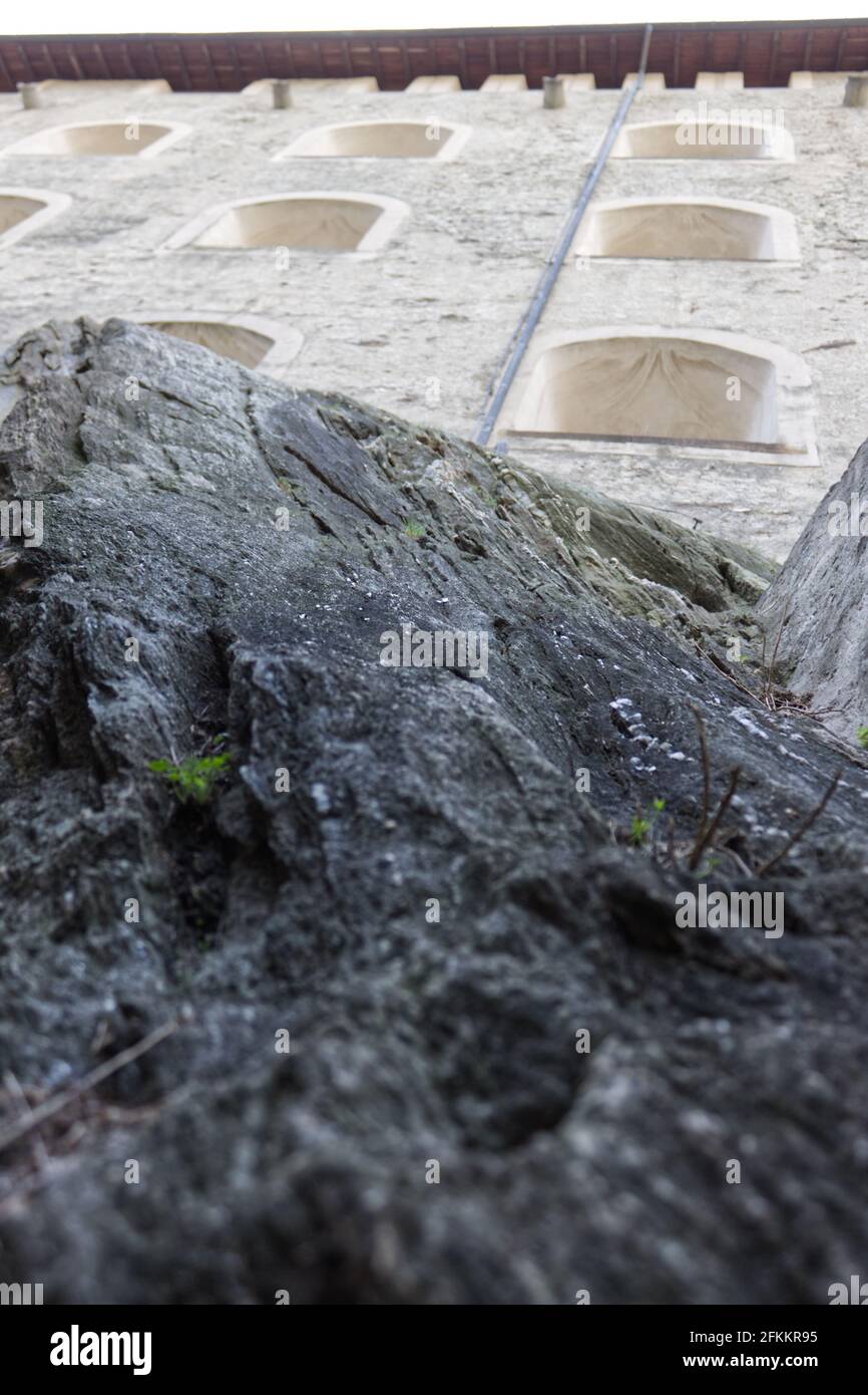 The textured surface of the rock against the background of the building ...