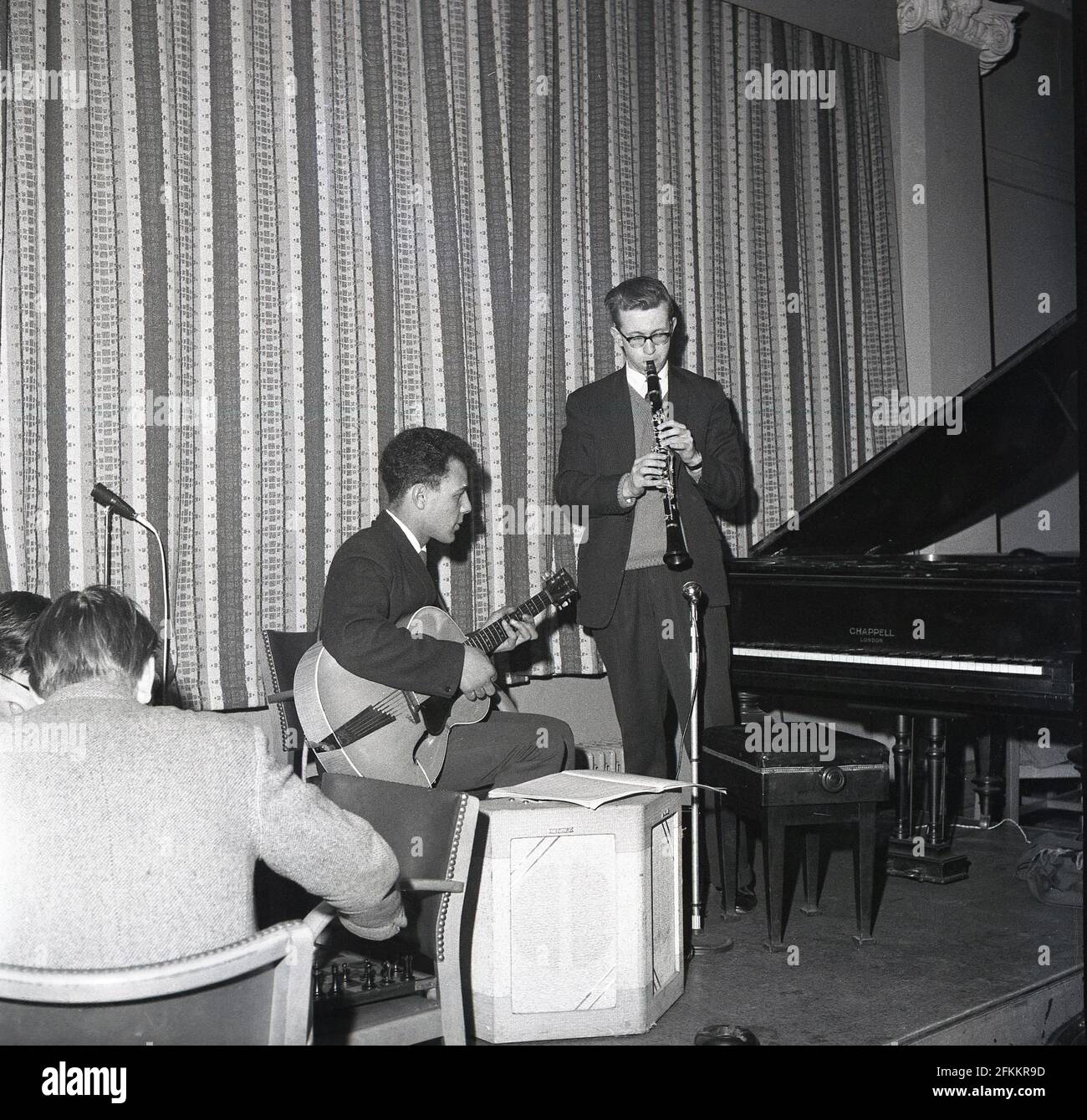 1960s, historical, on a stage in a lounge bar beside a Chappell piano ...