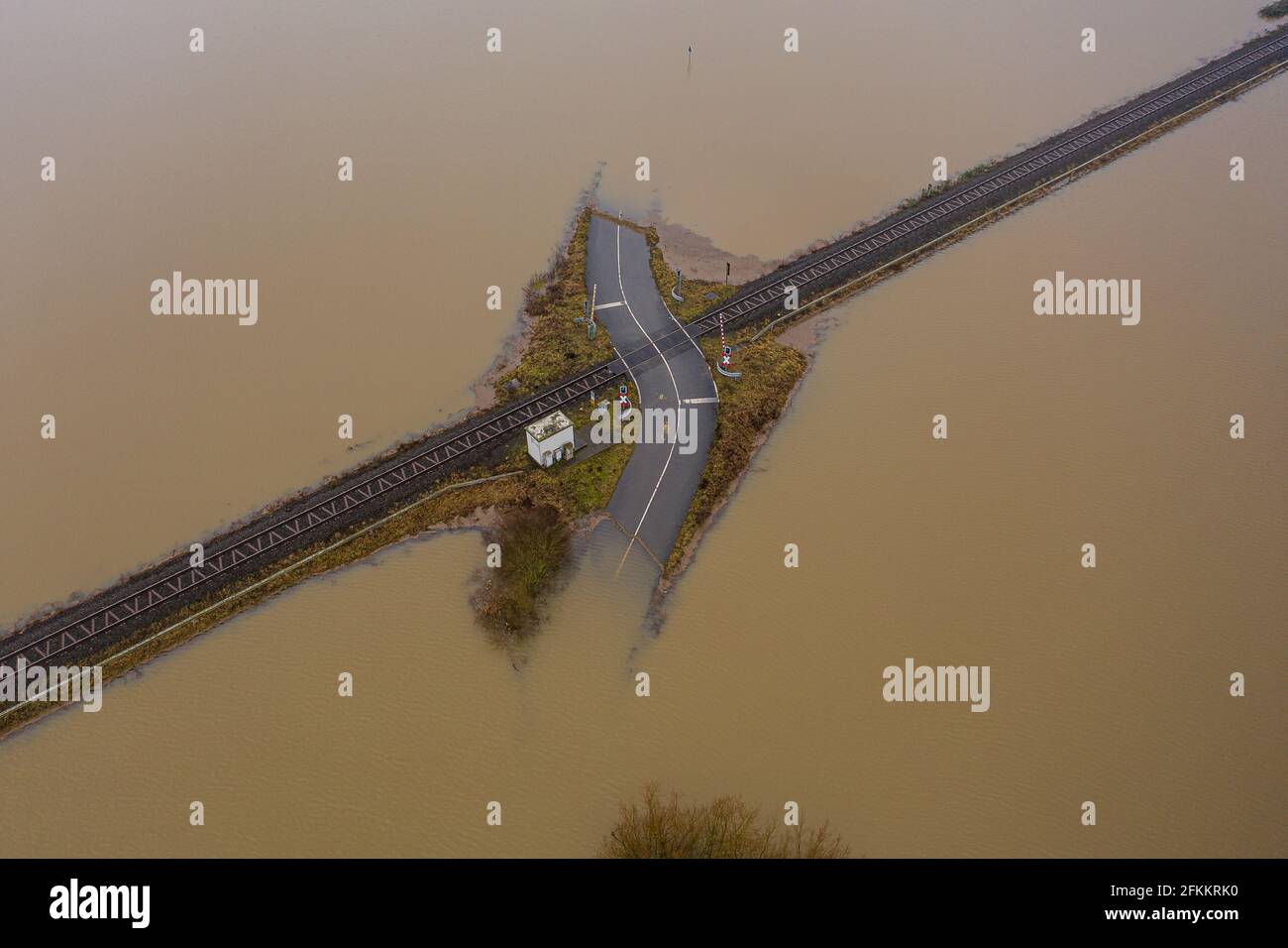 Flooded road passing through the railway. A road under water Stock ...