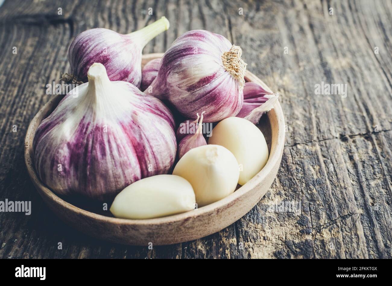 Rustic style garlic on vintage wooden background. Fresh young peeled ...