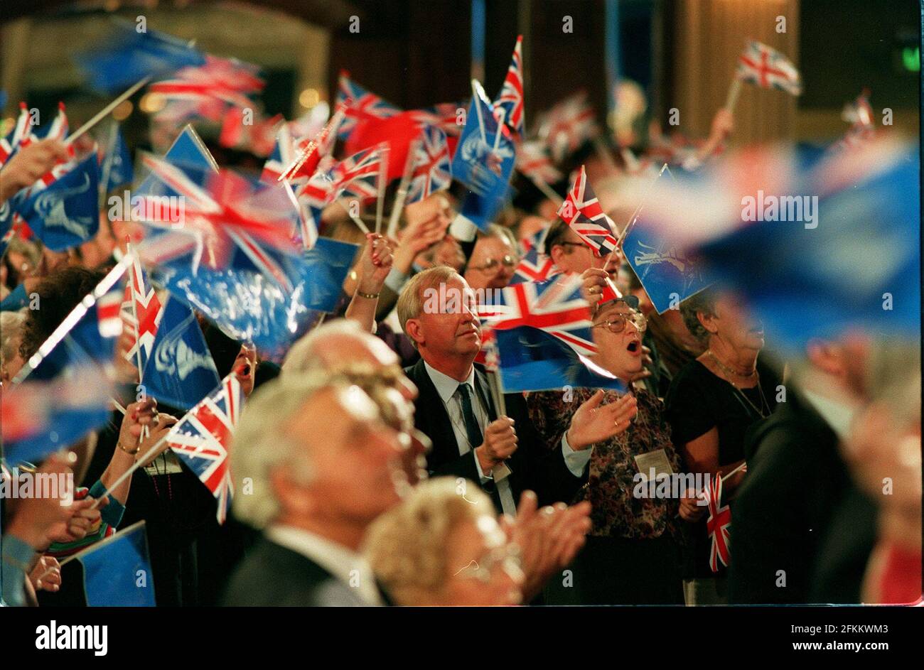 The crowd cheers and waves flags at the Conservative Party Conference ...