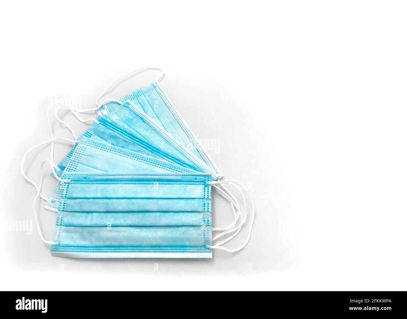 group of surgical masks on a white background with copy space, blue ...