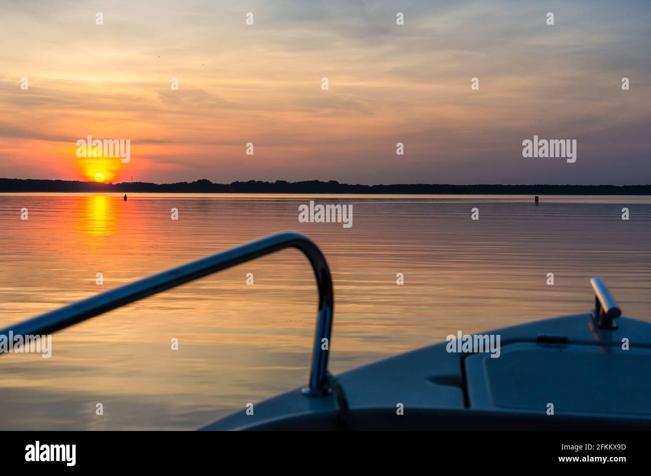 Masurian lake, sunset, motor boat Stock Photo - Alamy