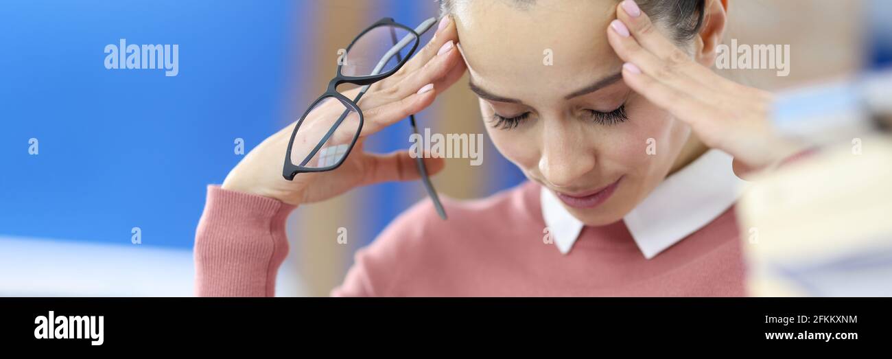 Tired woman at the work table. irregular working hours Stock Photo - Alamy