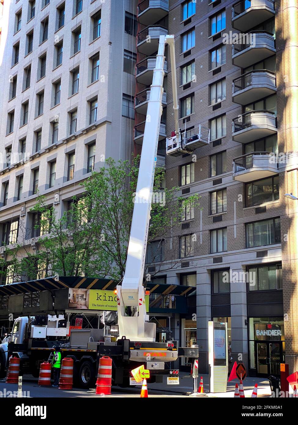 New York, NY, USA - May 3, 2021: Moving a heavy object from the street ...
