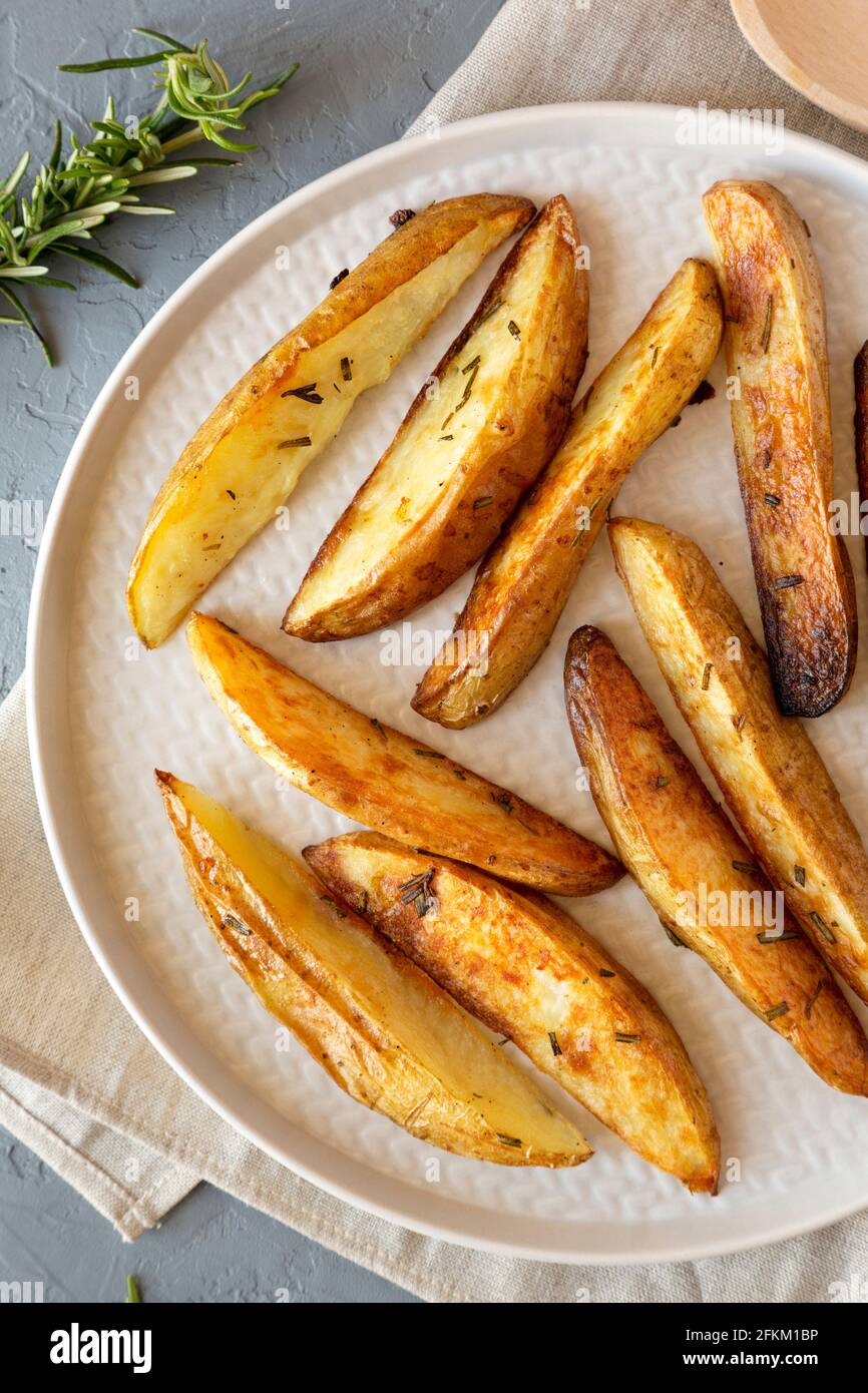 Homemade Rosemary Potato Wedges on a plate, top view. Flat lay ...