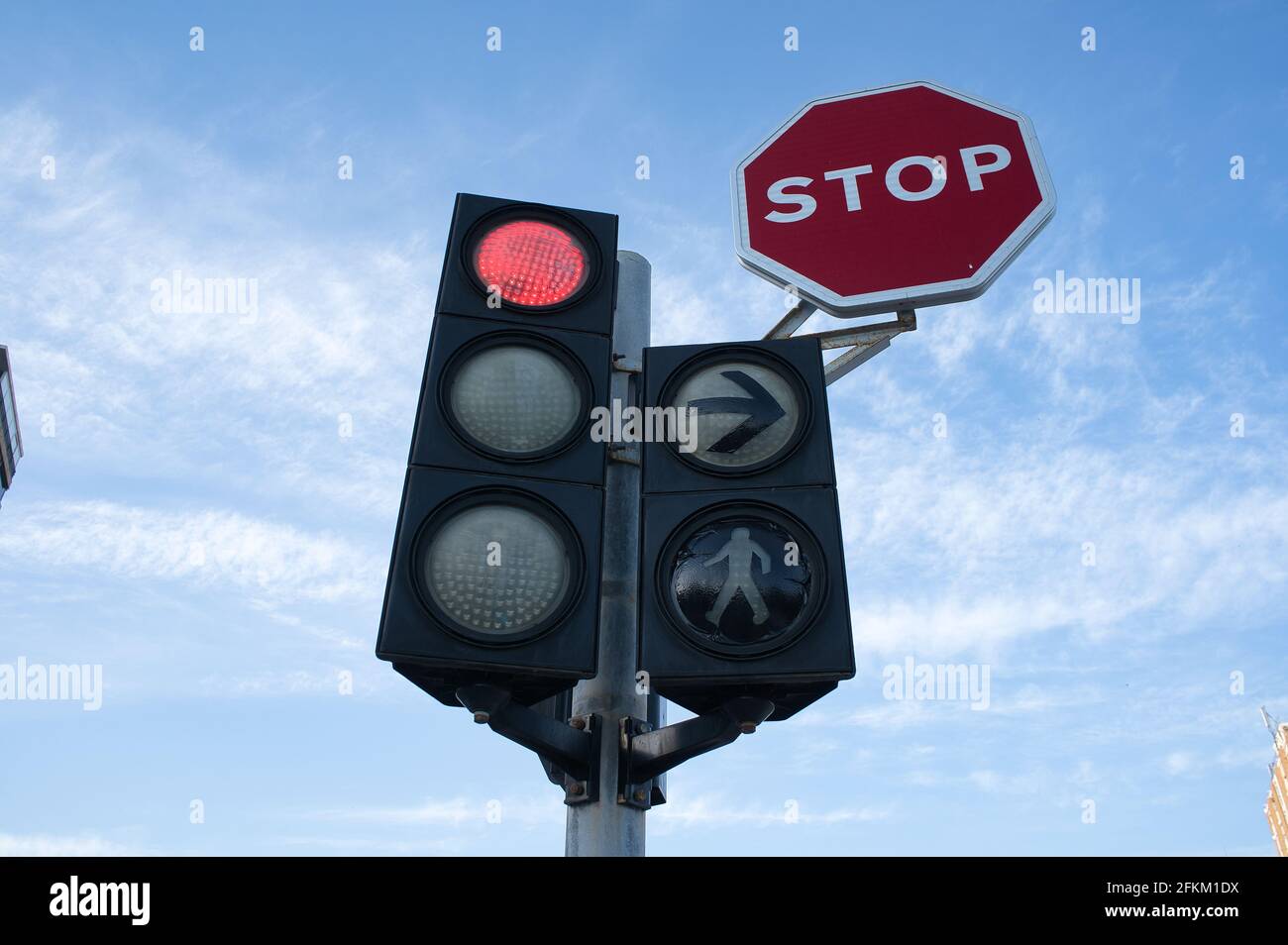traffic light and traffic sign viewed from below with sky and clouds in ...