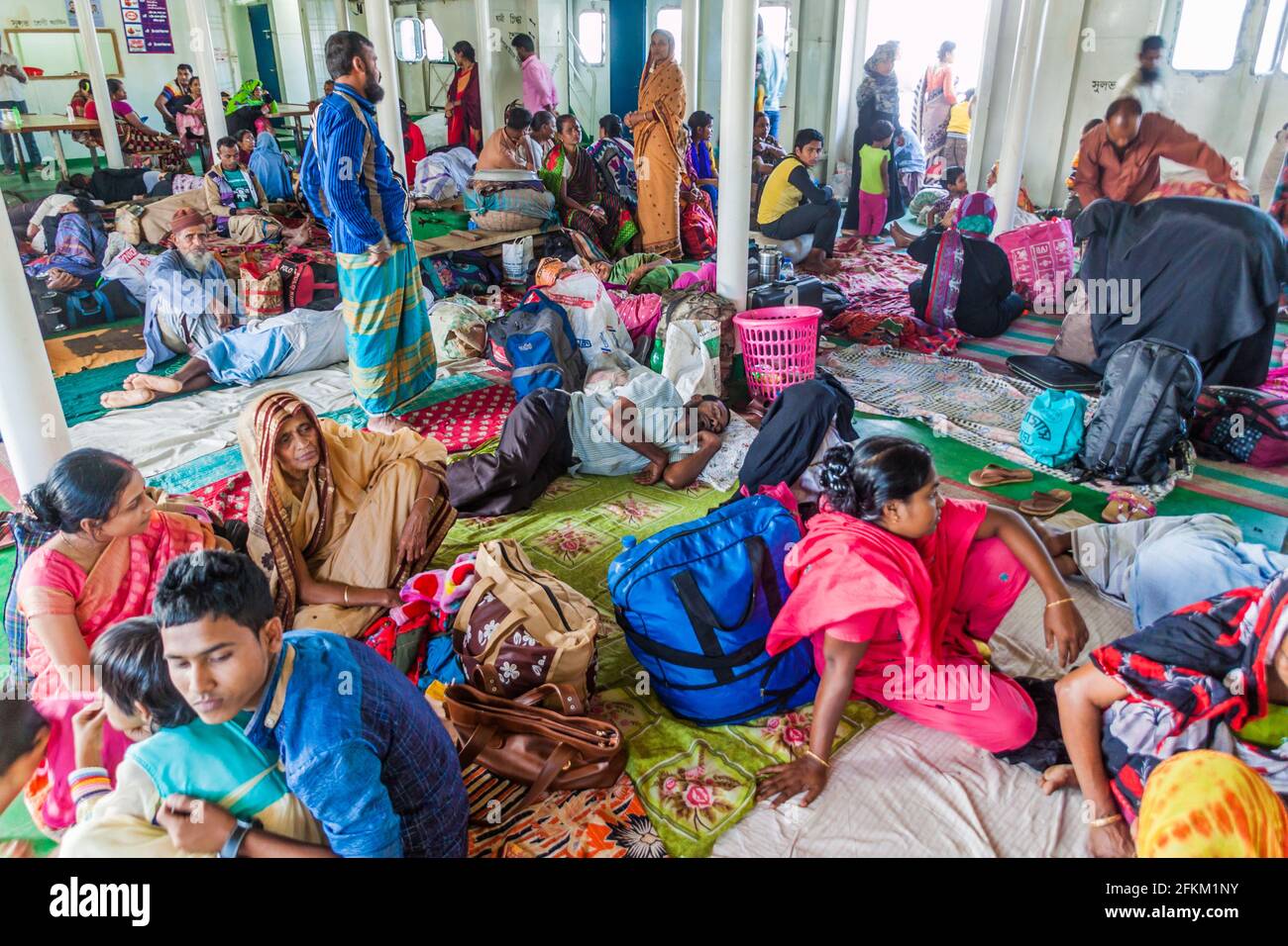 BISHKHALI RIVER, BANGLADESH - NOVEMBER 19, 2016: Passengers of the ...
