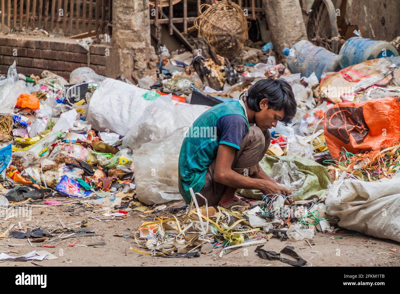 DHAKA, BANGLADESH - NOVEMBER 20, 2016: Local scavenger collects garbage ...