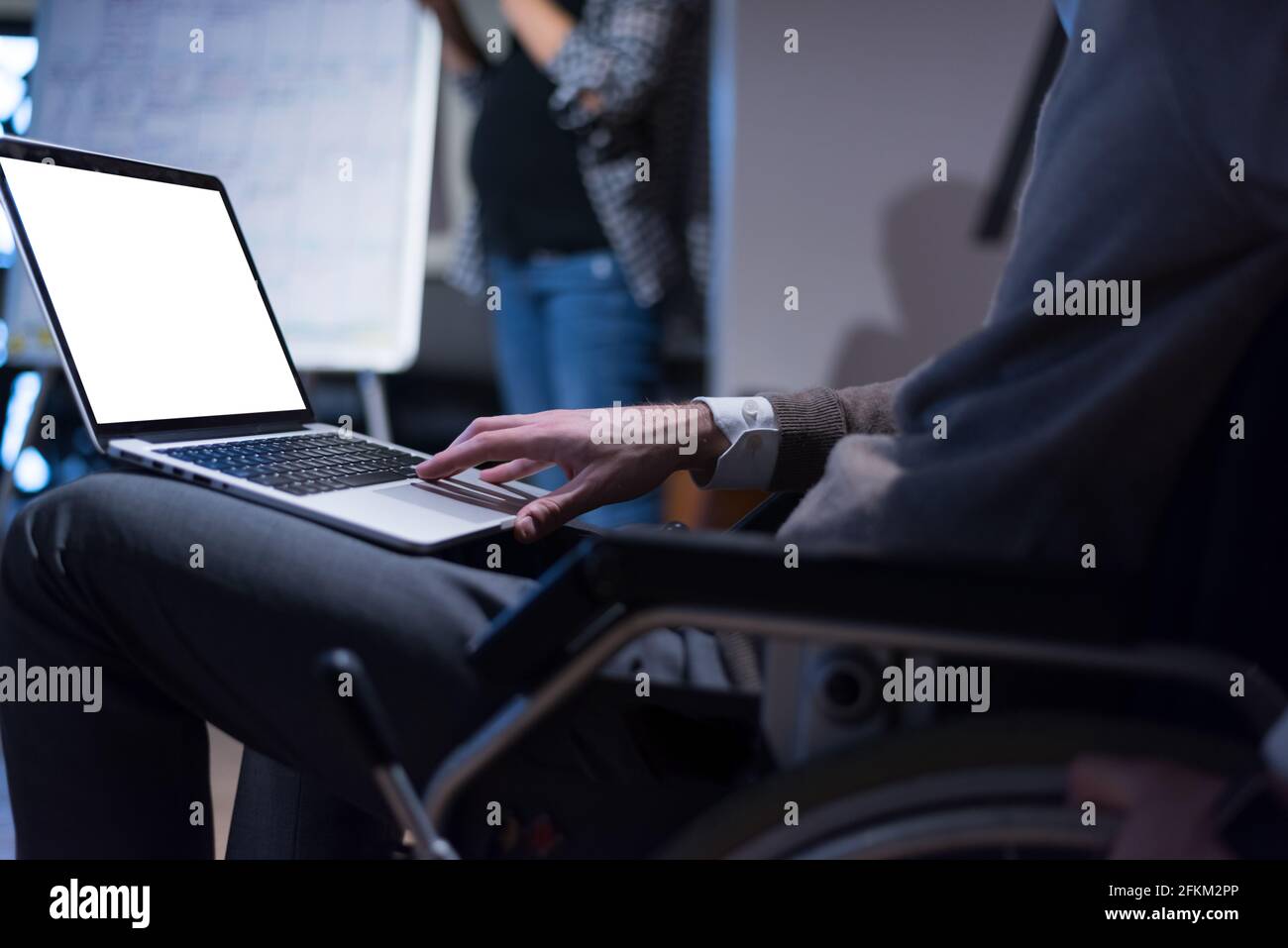 Young businassman in wheelchair using computer laptop at modern ...