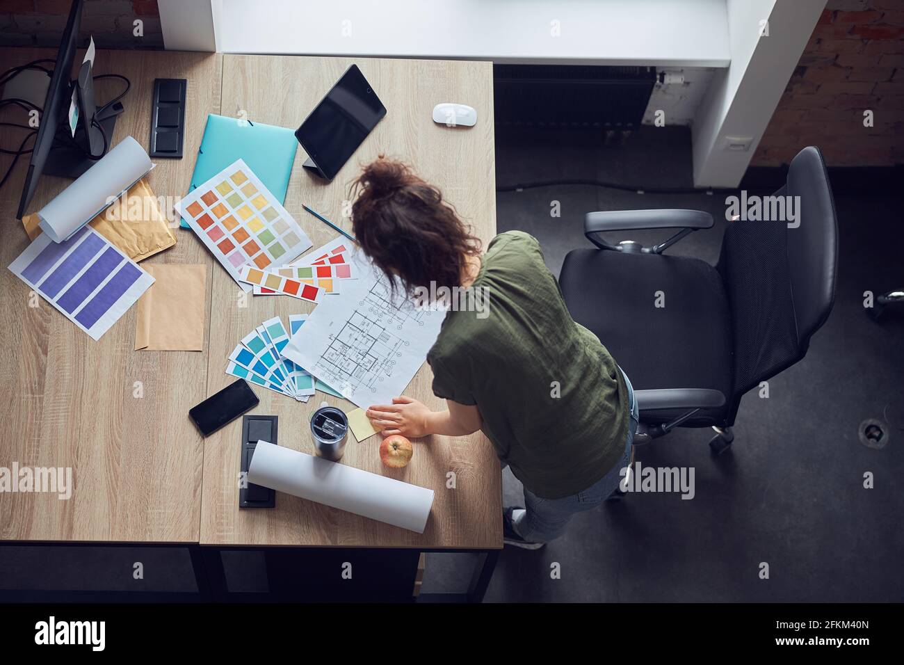 Top view of interior designer or architect in casual wear with messy ...