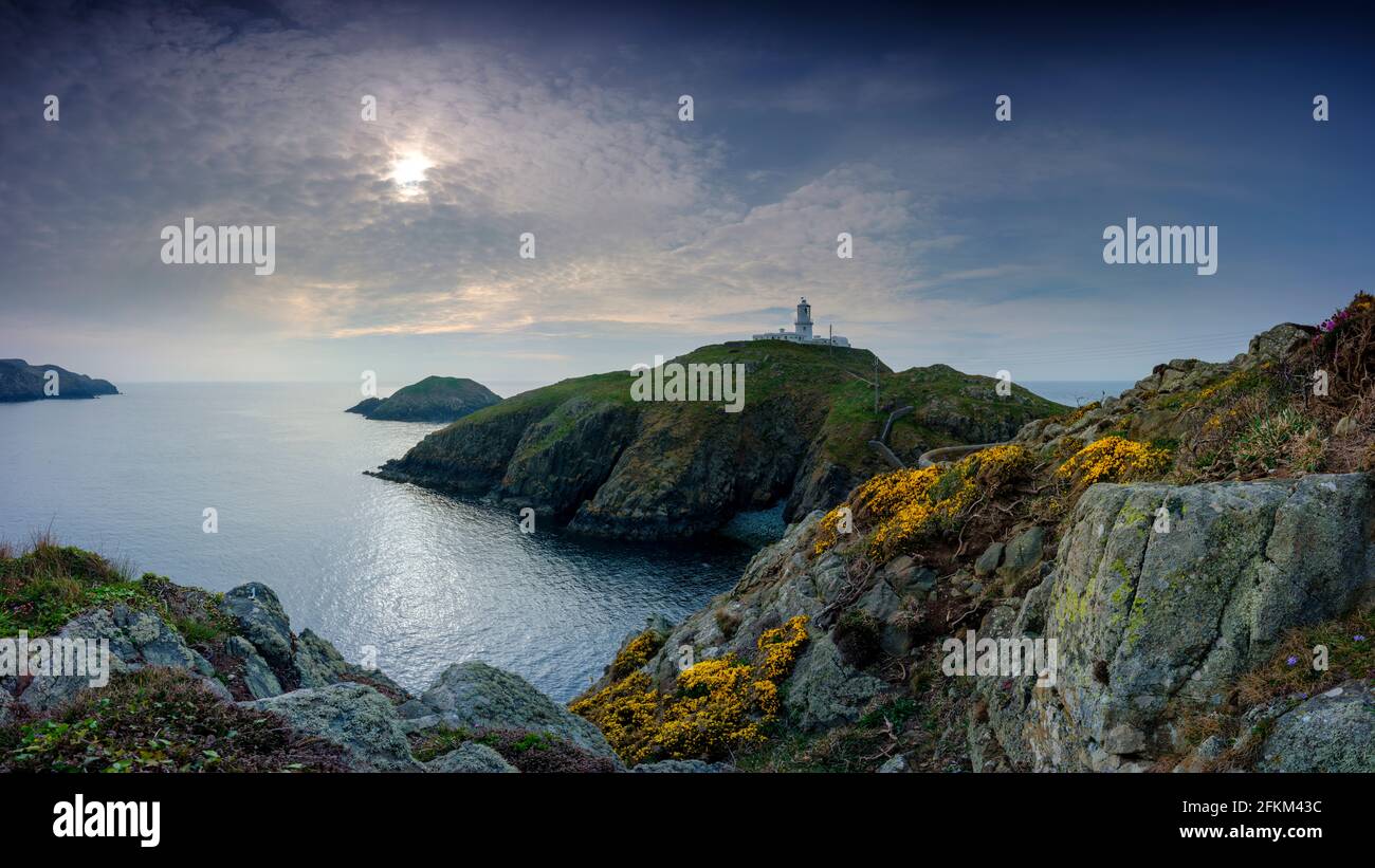 Fishguard, UK - April 20, 2021: Sunset over Strumble Head light house ...