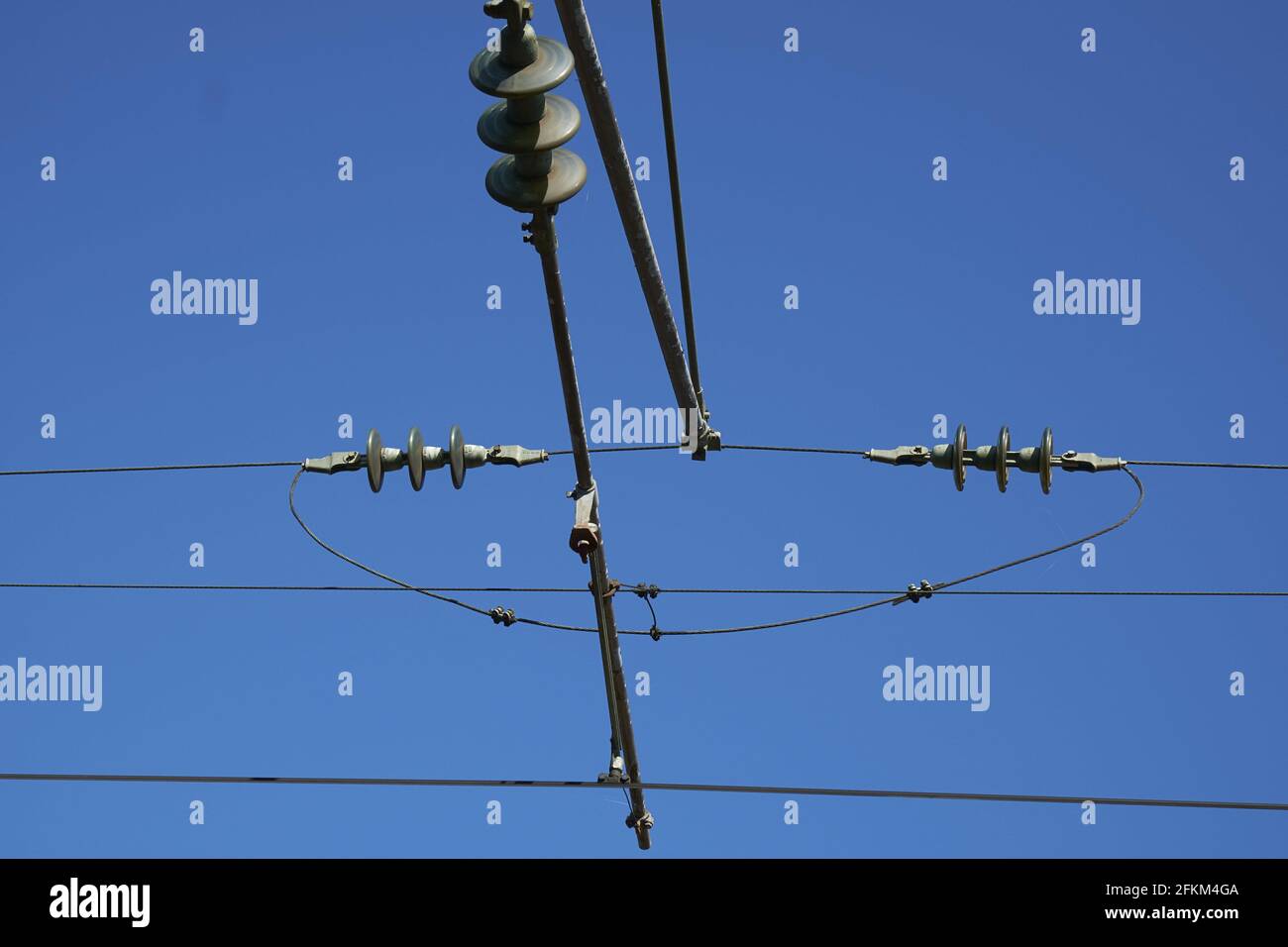 A low angle shot of transmission power lines under the sunlight and a ...