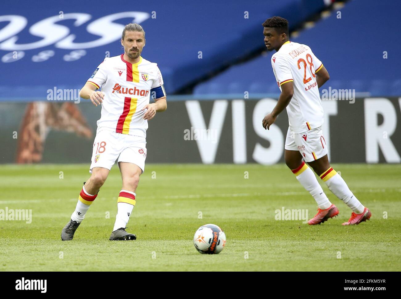 Yannick Cahuzac, Cheick Doucoure of Lens during the French championship ...
