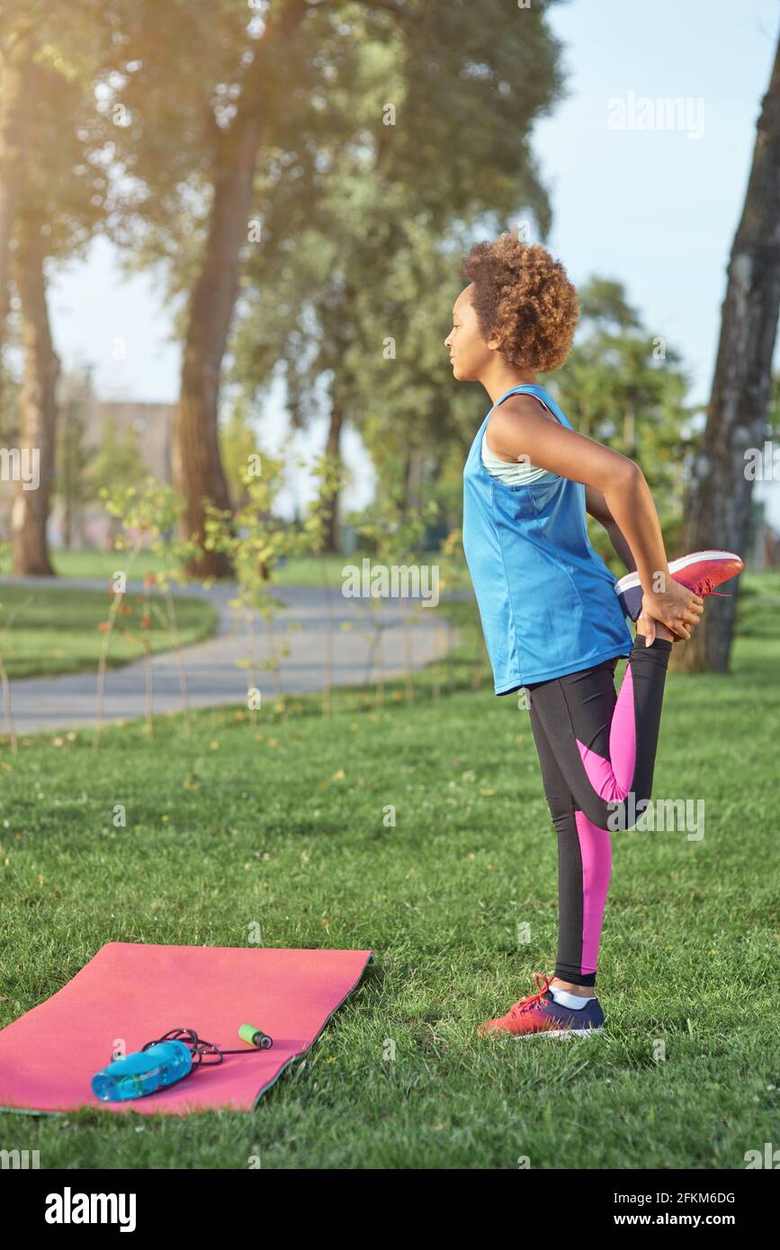 Sporty Afro American girl doing morning gymnastics outdoors Stock Photo ...