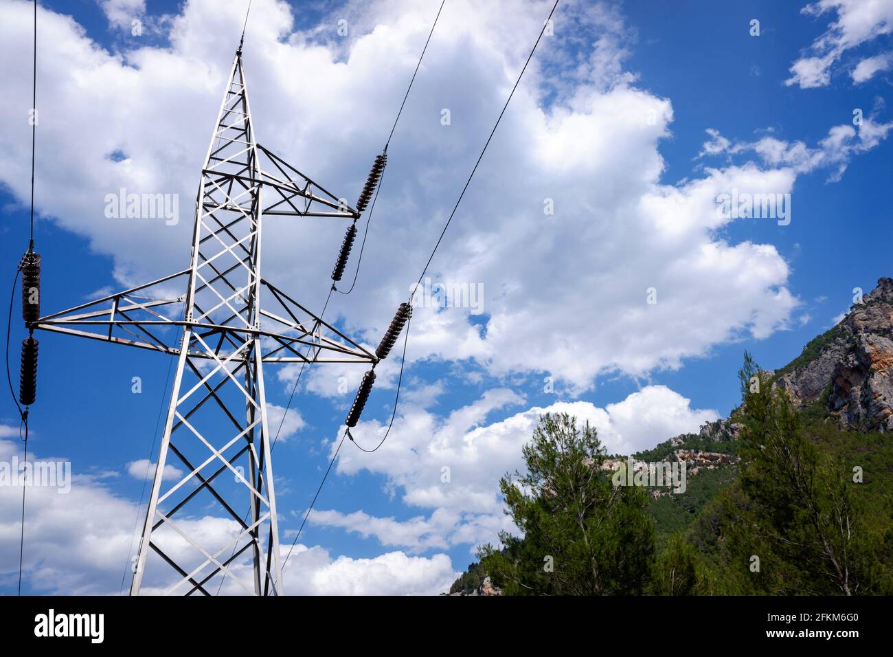 Power lines run through mountains to supply electricity to cities Stock ...
