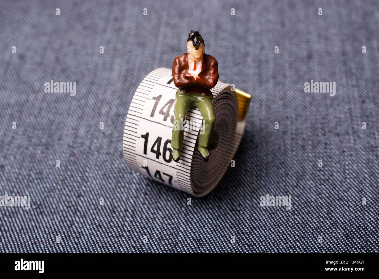 Man figurine and soft measuring tape. tape measure with metric scale ...