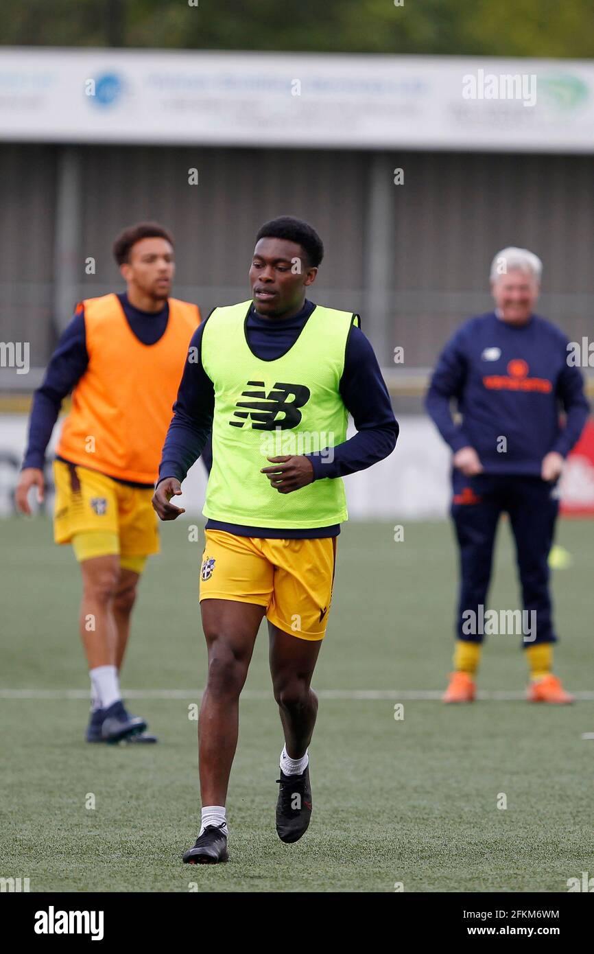 SUTTON, United Kingdom, MAY 01: Isaac Olaofe of Sutton United warming ...