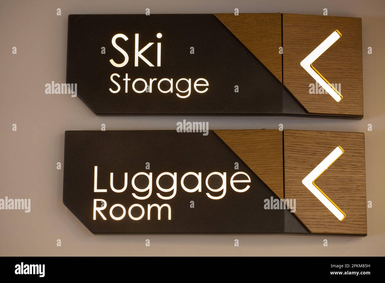 The ski storage and luggage room signs with direction arrow on the wall ...