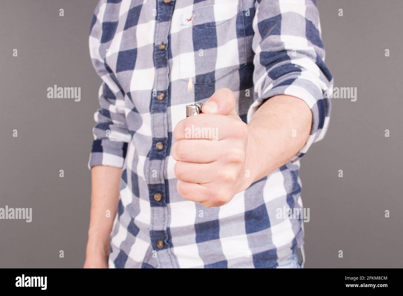 Man holding lighter Stock Photo - Alamy