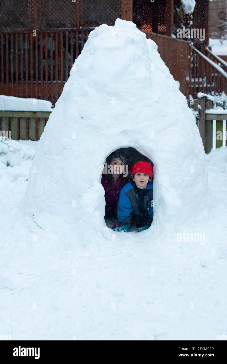 Two children inside a snow fort in the winter Stock Photo - Alamy