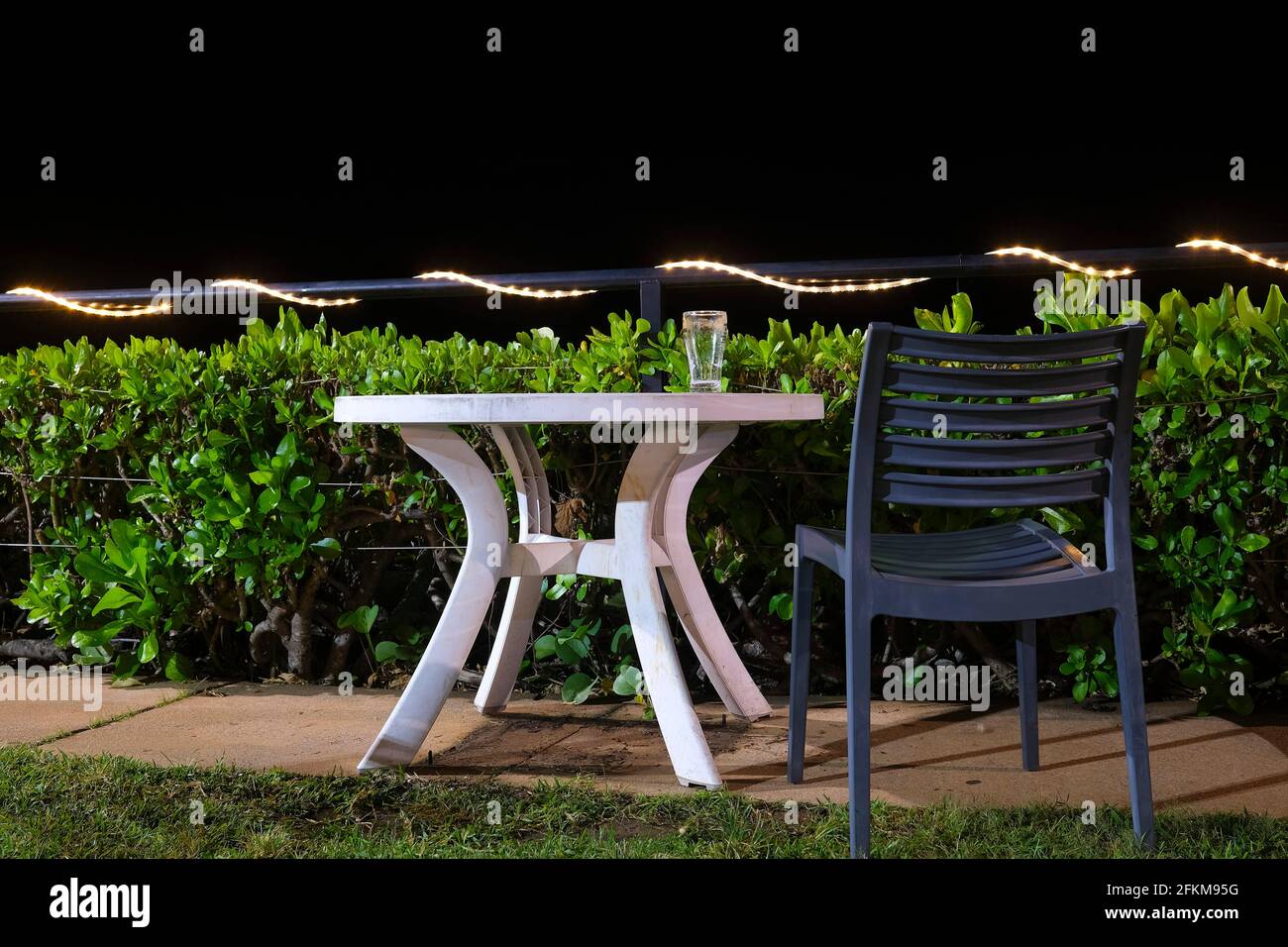 Table with empty beer glass at night outdoor Stock Photo - Alamy