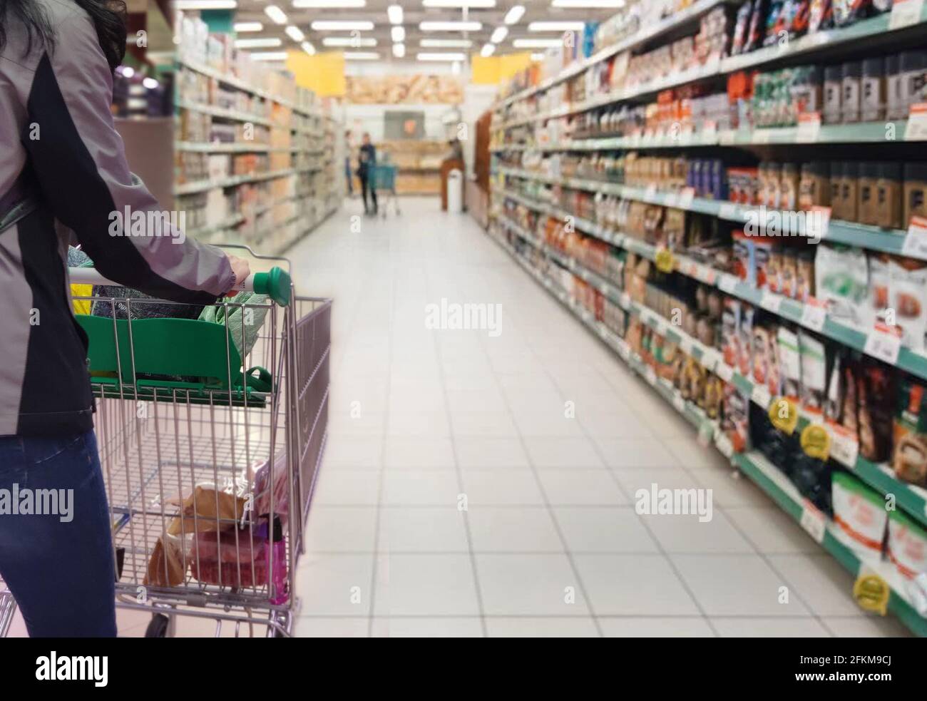A person with cart in supermarket, lifestyle concept Stock Photo - Alamy