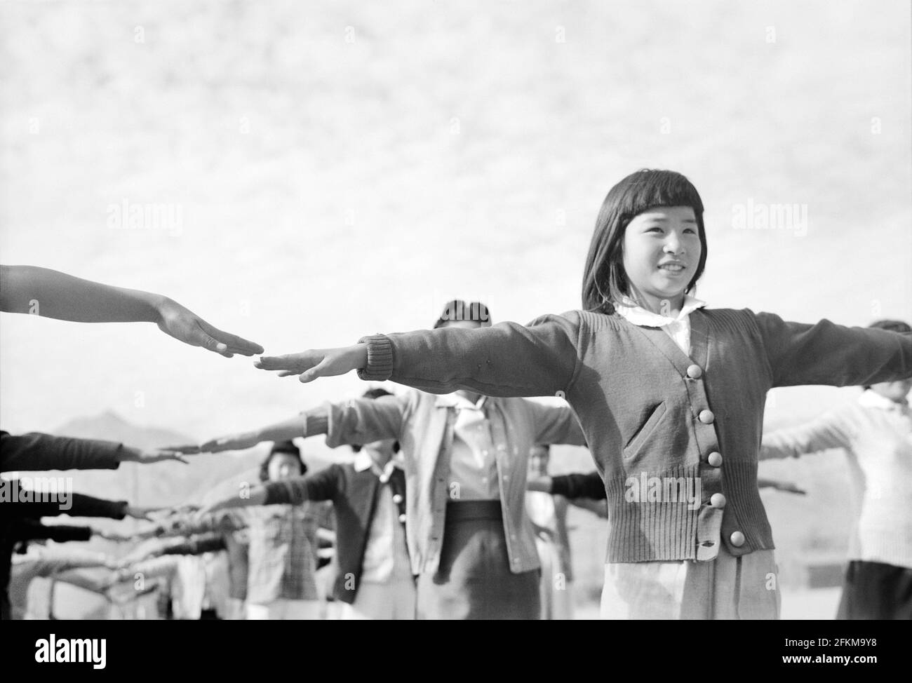 Group of School Girls doing Calisthenics, arms extended out, Manzanar ...