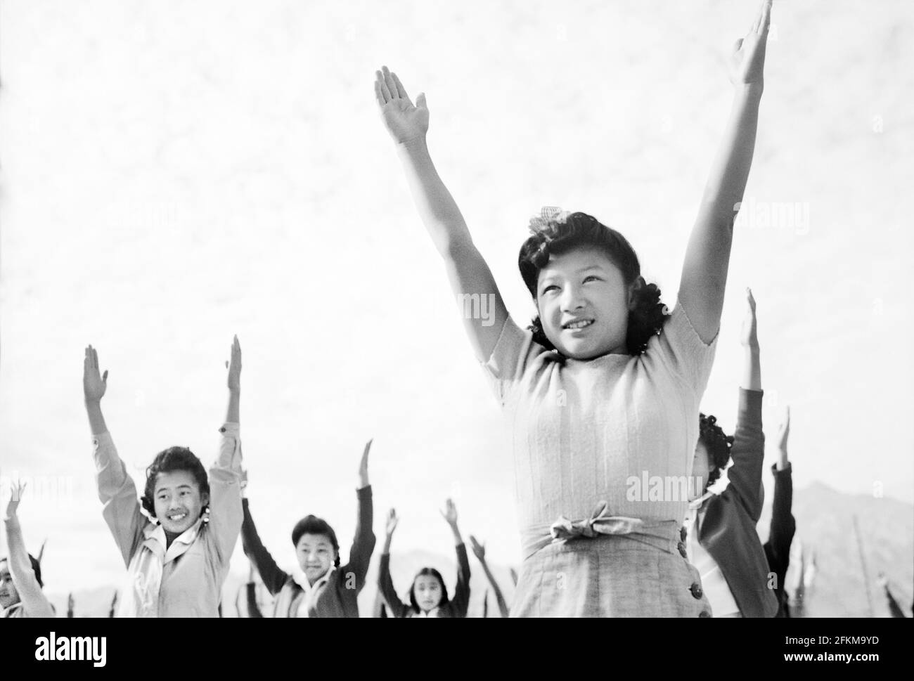Group of School Girls doing Calisthenics, arms extended up, Manzanar ...
