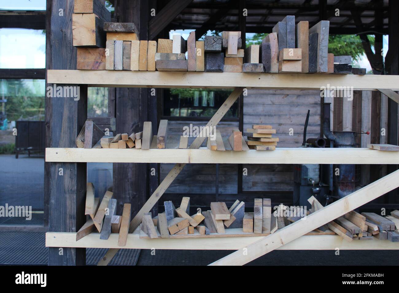 Assorted pieces of wood on tiered shelf, in carpentry shop Stock Photo ...