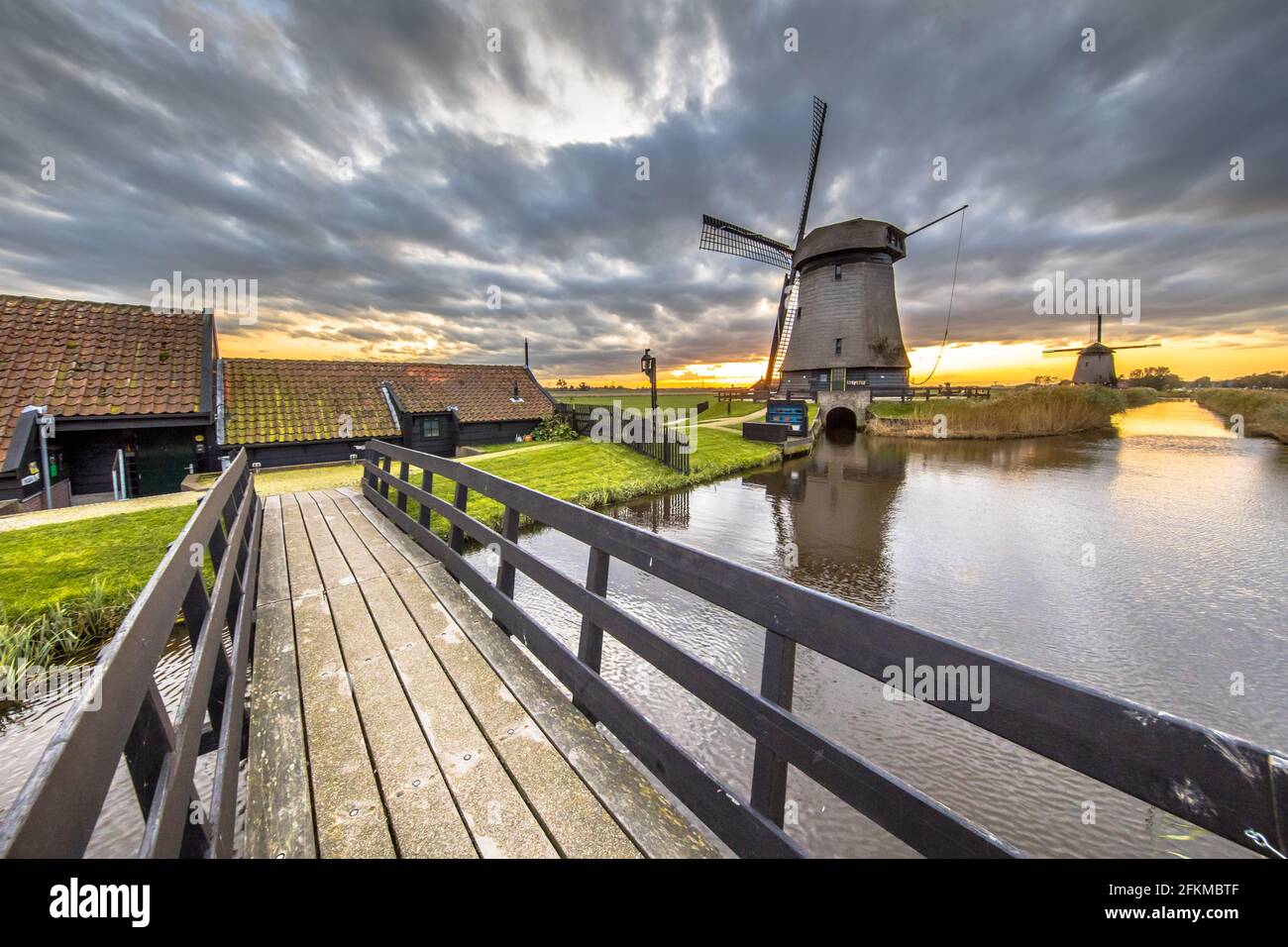 Bridge to Traditional wooden windmill in old agricultural landscape ...