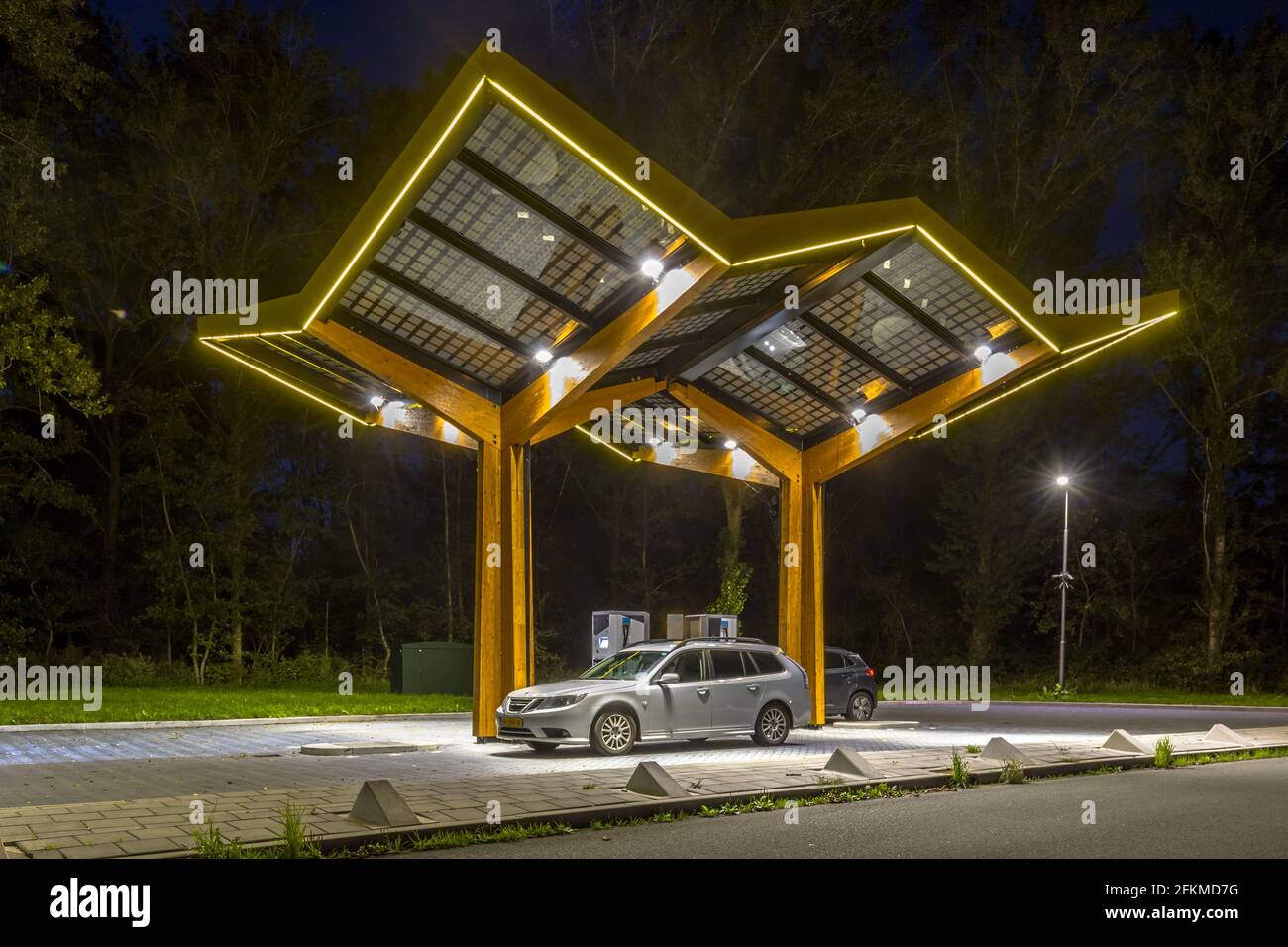 Electric cars charging at electricity filling station in the fast ...