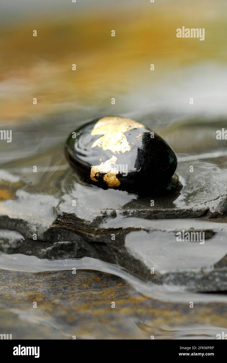 Stone with gold tinsel, decorative stone Stock Photo - Alamy
