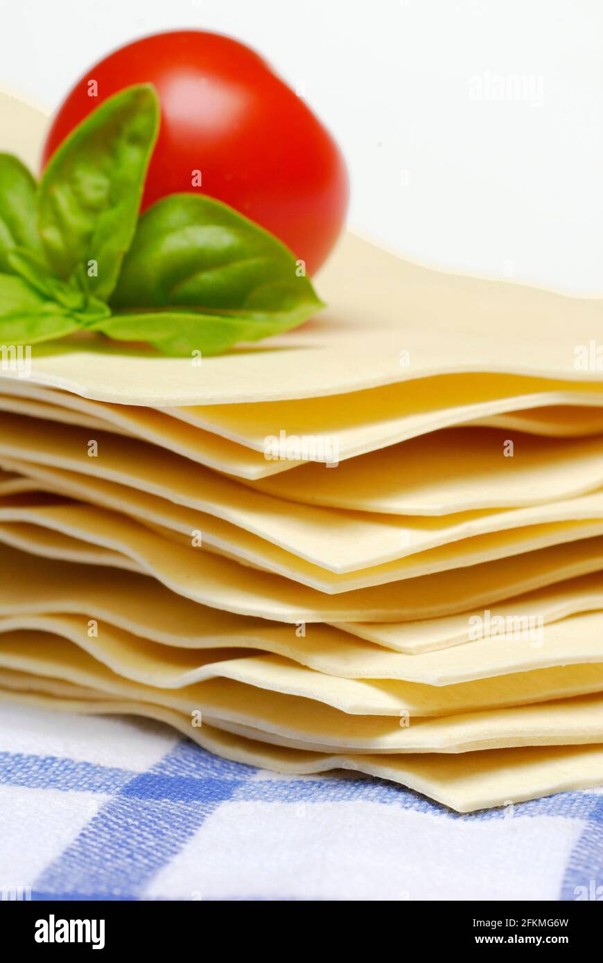Uncooked lasagne leaves, tomato and basil, pasta, noodles Stock Photo ...