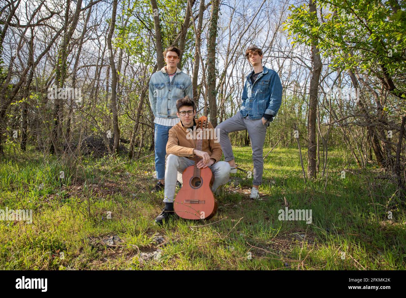 A band of young artists poses for a photo into a forest Stock Photo - Alamy
