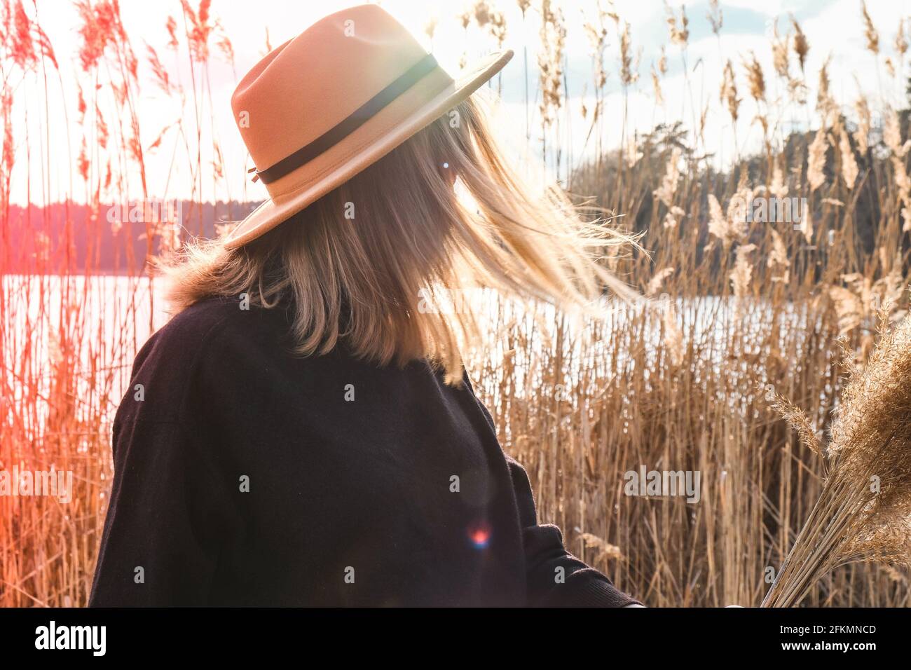 European blonde woman with beige hat in black sweater in the ...