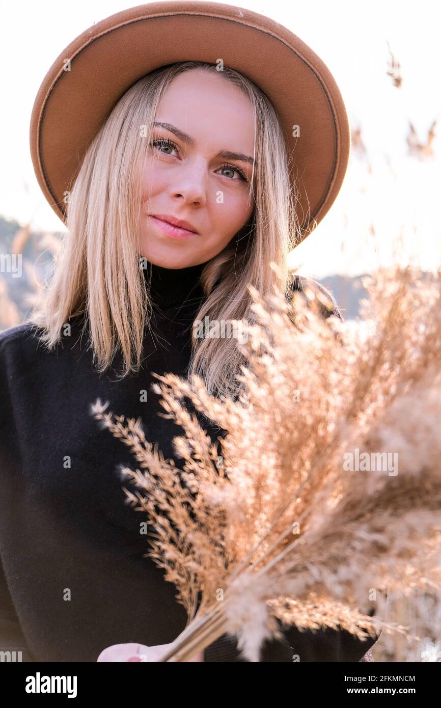 European blonde woman with beige hat in black sweater in the ...