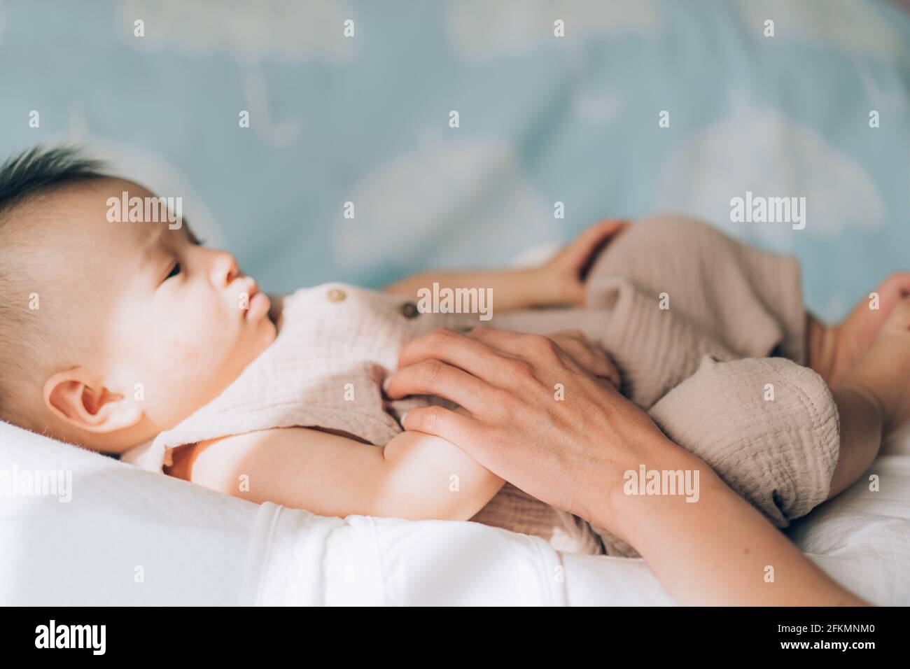 Child adoption and In Vitro Fertilization IVF . Asian child lying on ...